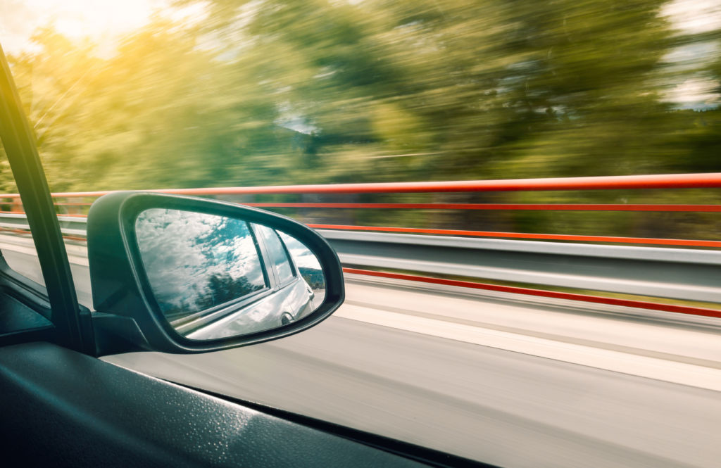 The reflection in the rear-view mirror of car in motion · Free Stock Photos
