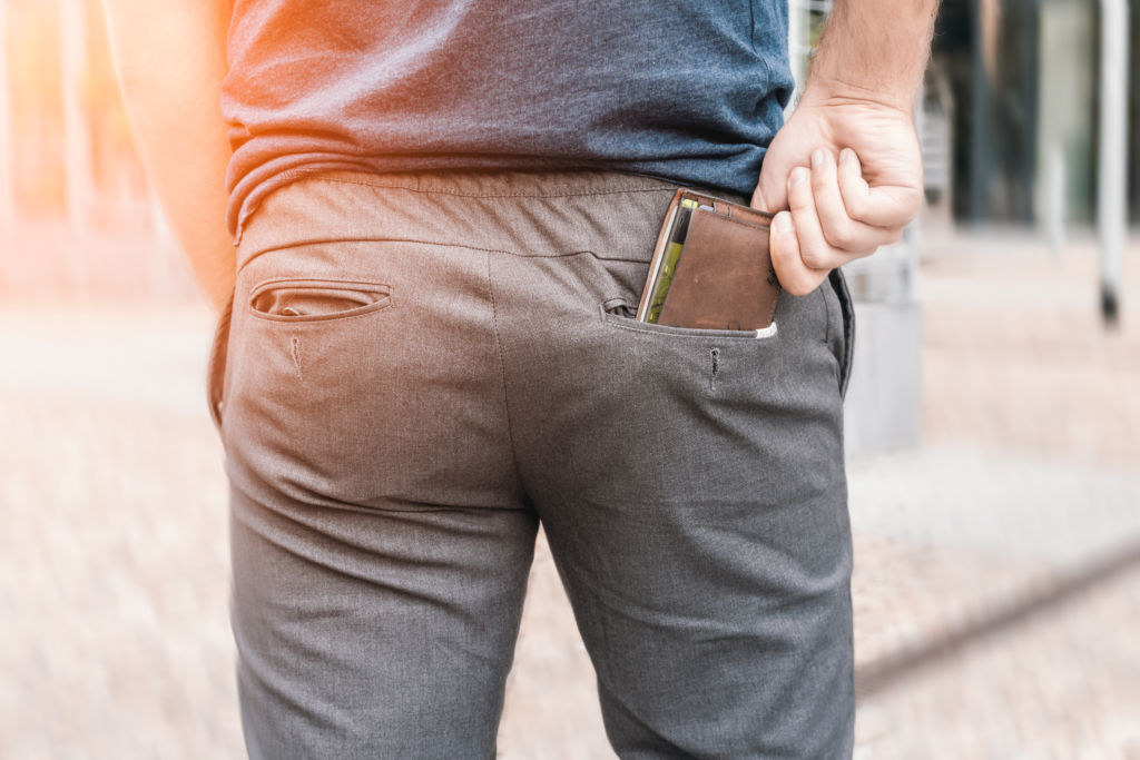 Man’s hand taking wallet from his own pocket · Free Stock Photos