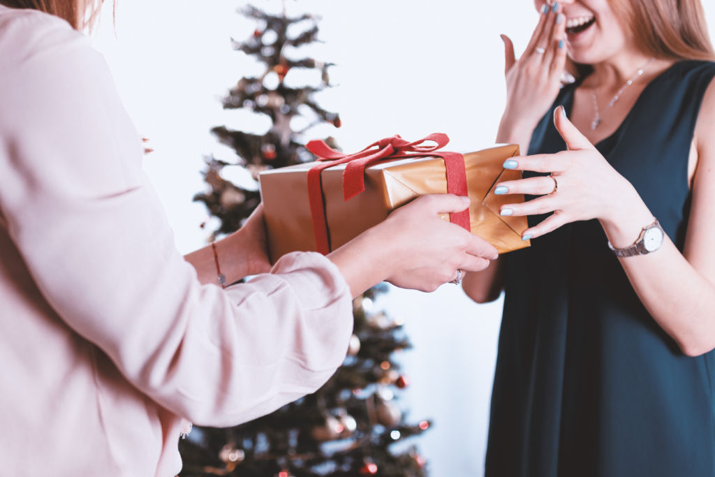 Happy and surprised woman receiving a gift. Merry Christmas · Free ...